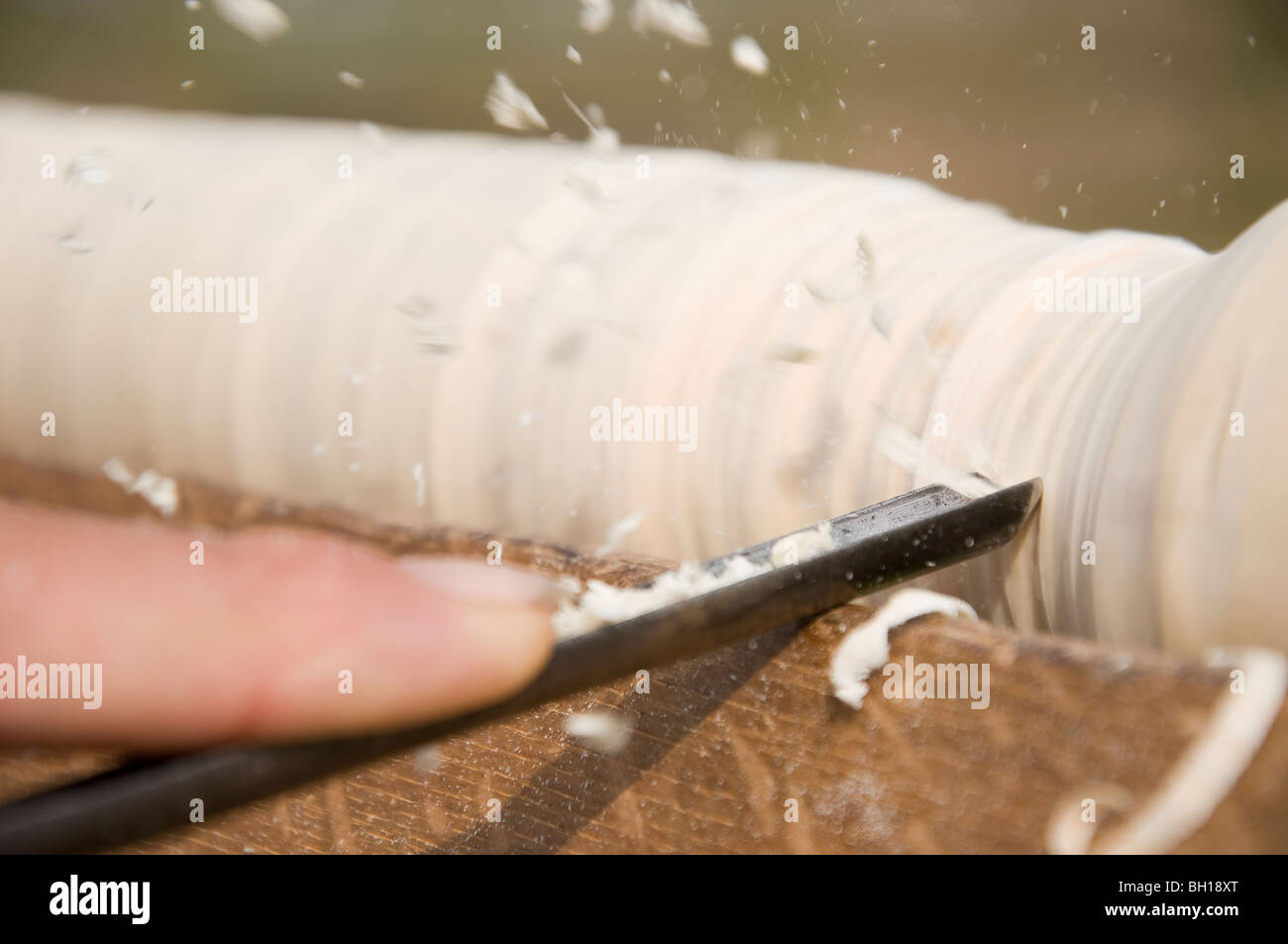 Woodturning using a traditional foot powered lathe to turn a spindle ...