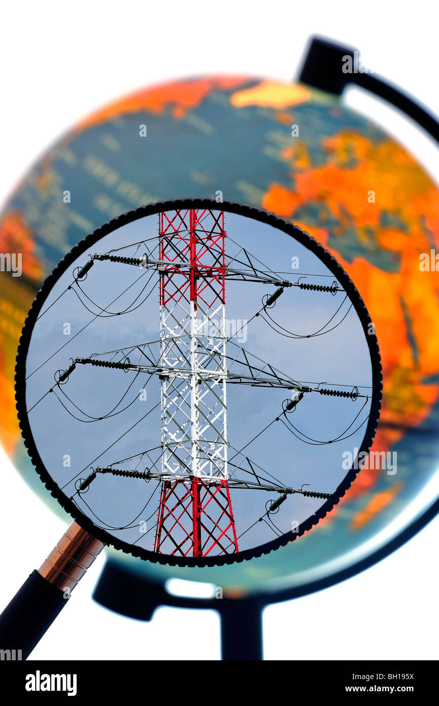 High voltage pylon in red and white through magnifying glass held ...