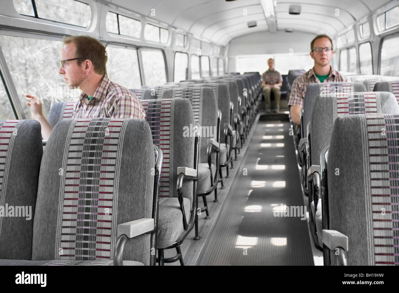 Three men on a bus Stock Photo - Alamy