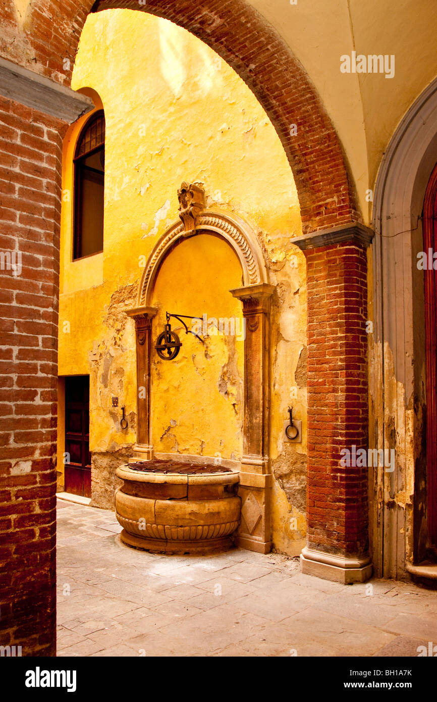 Courtyard water well in Siena, Tuscany Italy Stock Photo - Alamy