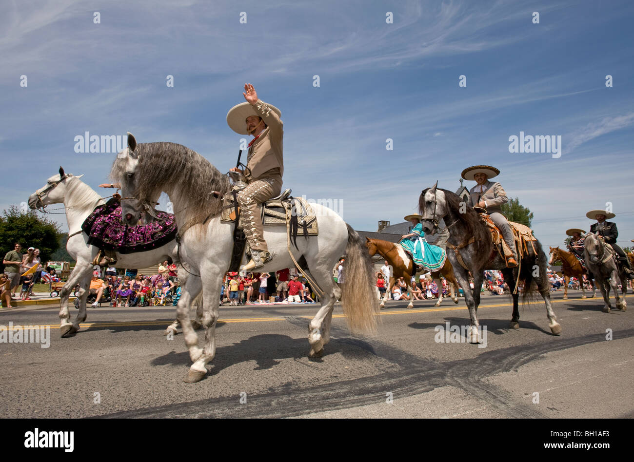 Mexican cowboys riding their horses through the street during the ...