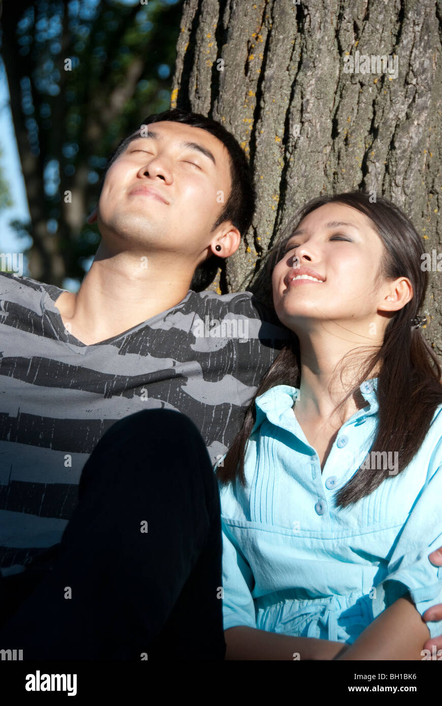 Young couple base tree faces hi-res stock photography and images - Alamy