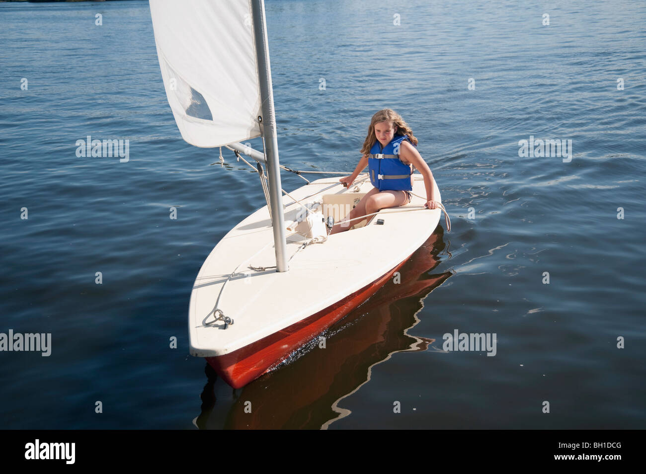Girl in small sailboat Stock Photo - Alamy