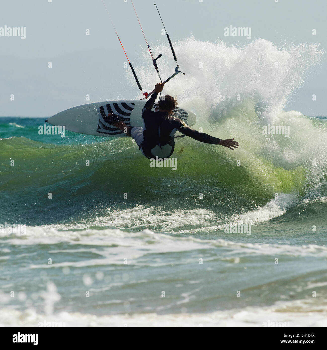 Kitesurfer catching a wave Stock Photo - Alamy