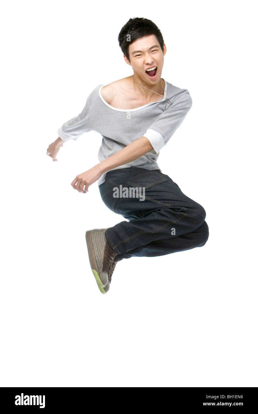 Young man jumping in mid-air Stock Photo - Alamy