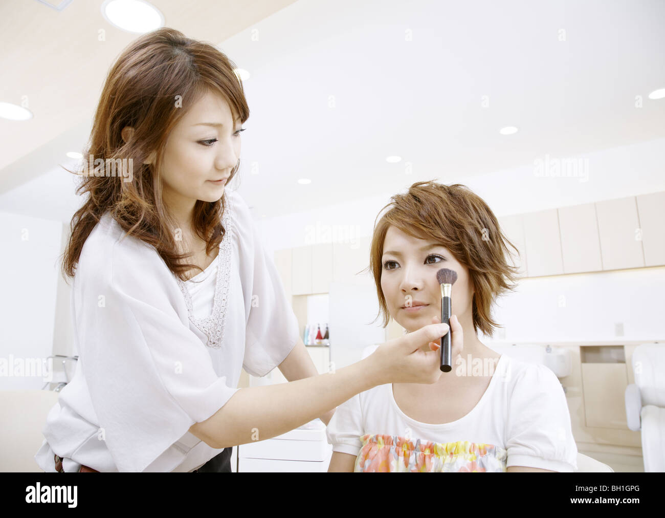 A young woman getting her makeup done Stock Photo - Alamy