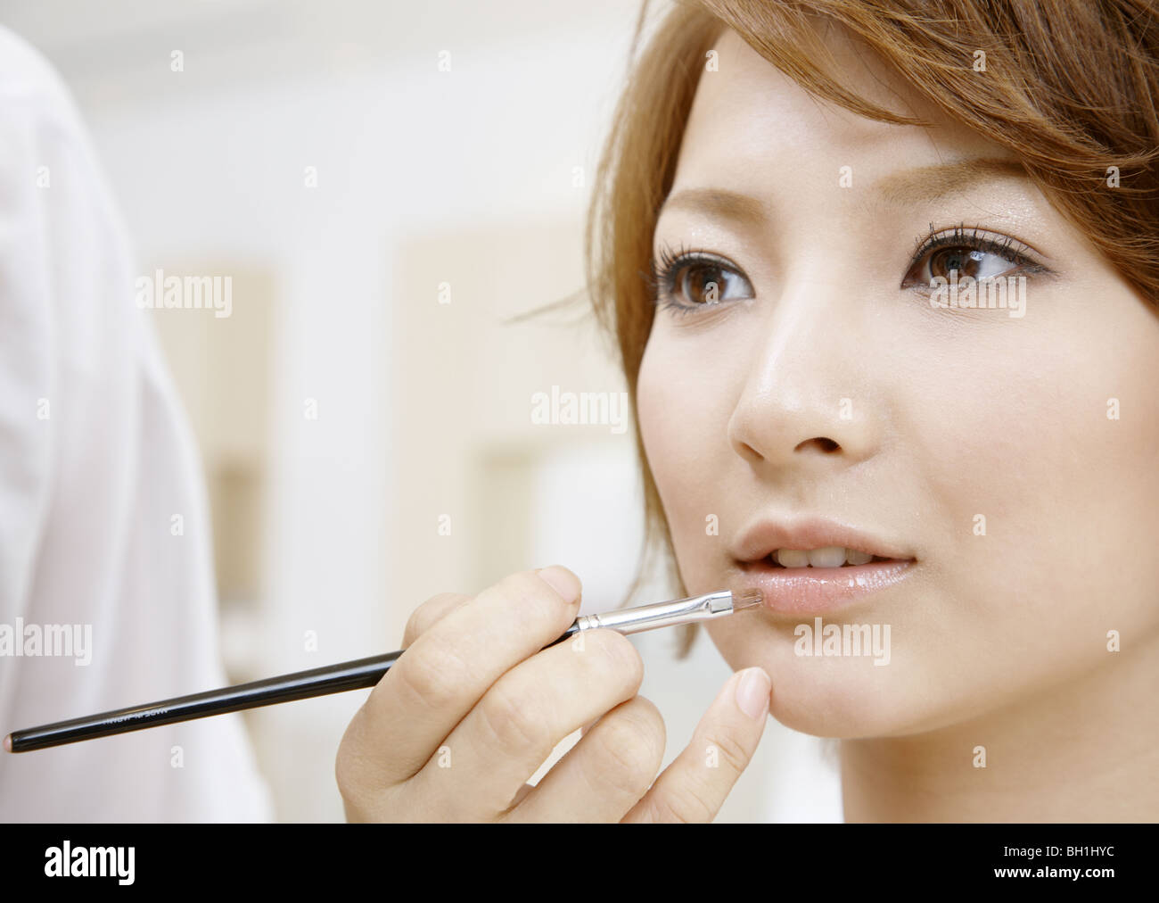 A young woman getting her makeup done Stock Photo - Alamy