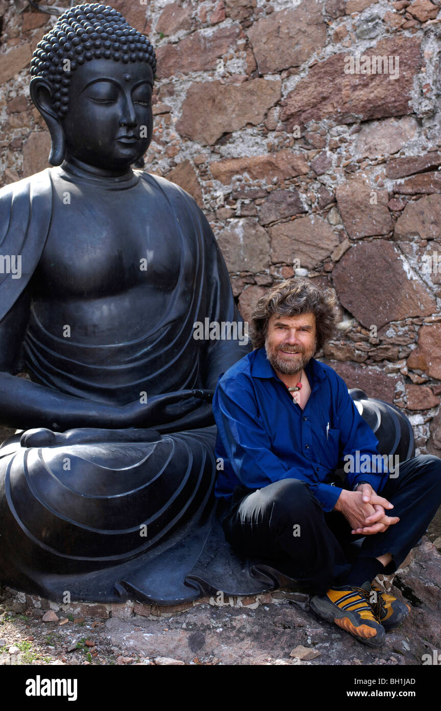 Reinhold Messner sitting in front of a Buddha statue, Extreme ...
