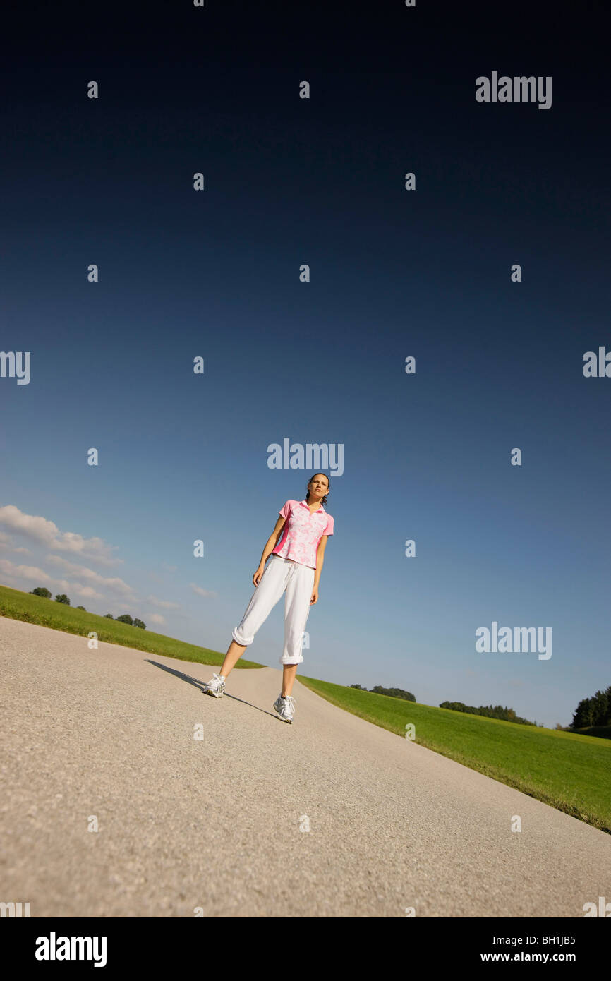 Woman standing on road, Munsing, Bavaria, Germany Stock Photo - Alamy