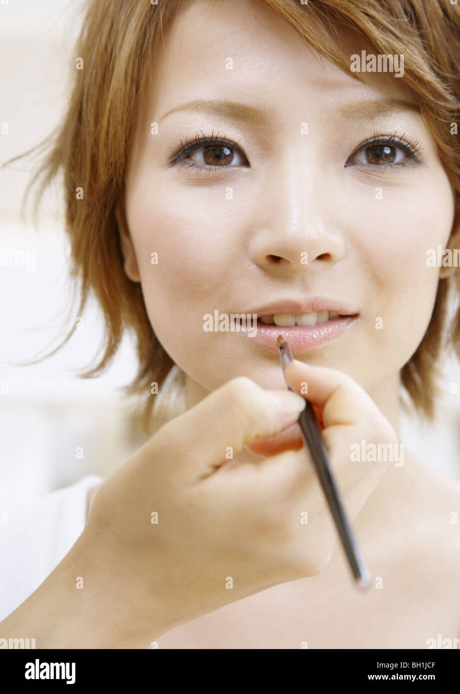 A young woman getting her makeup done Stock Photo - Alamy