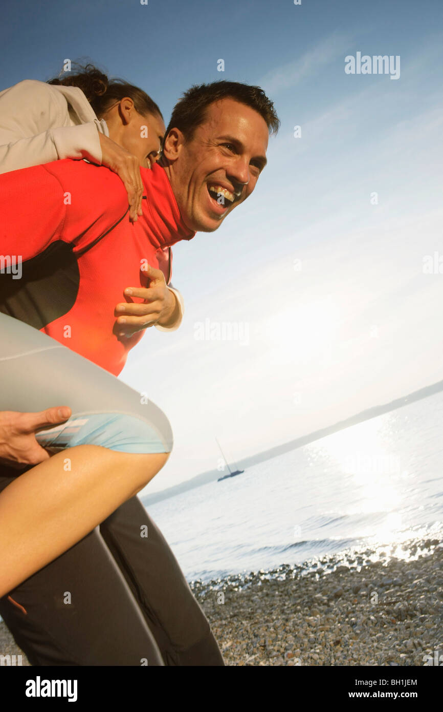 Man giving woman piggyback, Ambach, Bavaria, Germany Stock Photo - Alamy