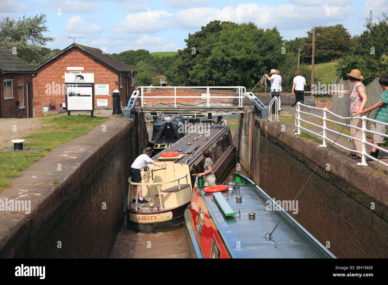 Three narrowboats negotiating positions in the double width Bunbury ...