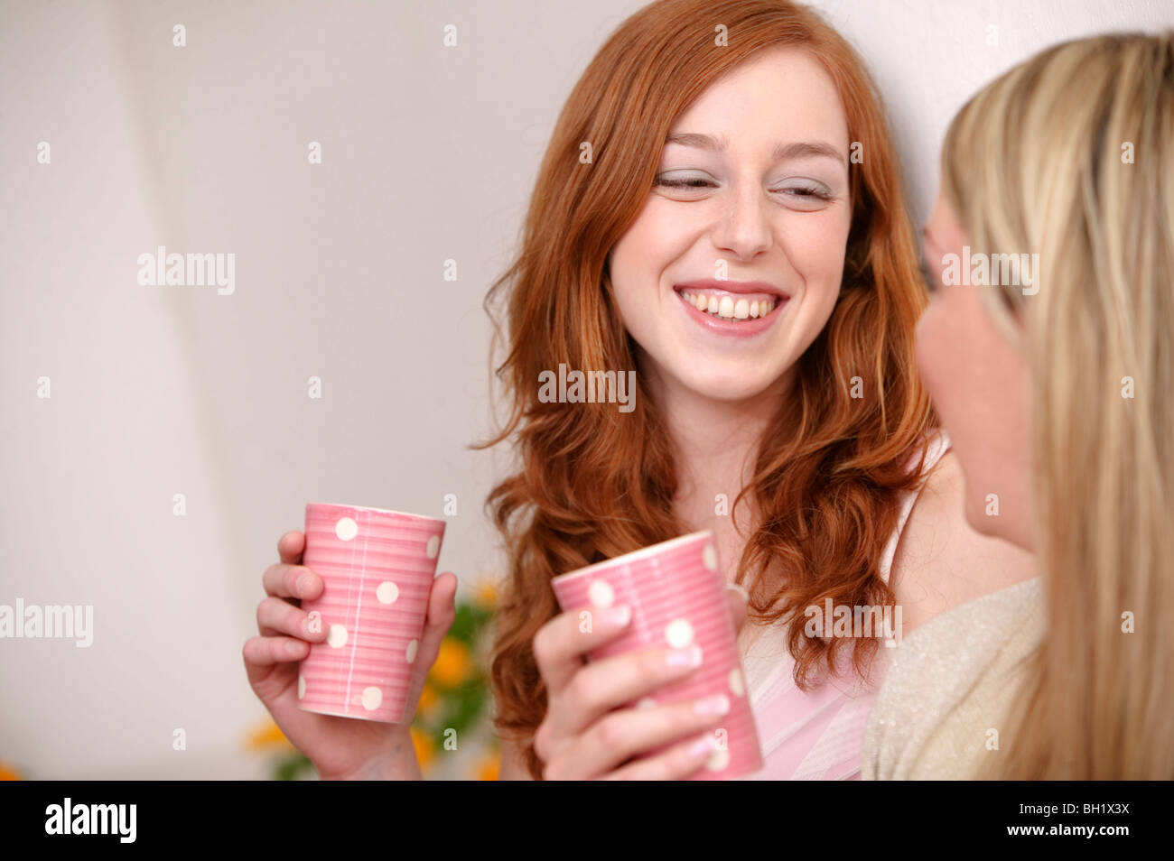 Two friends drinking tea Stock Photo - Alamy