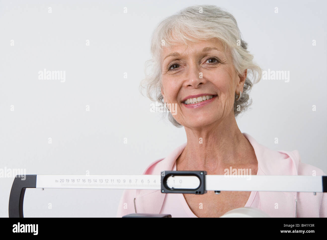 Senior woman stands on hospital scales Stock Photo - Alamy