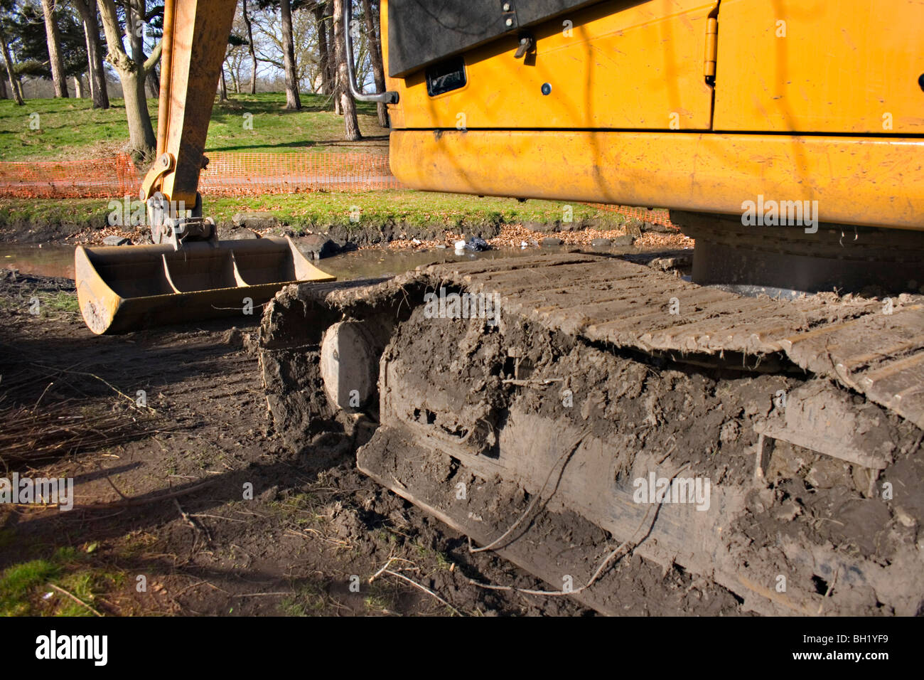 Yellow excavator clearing the ground ready for construction work to ...