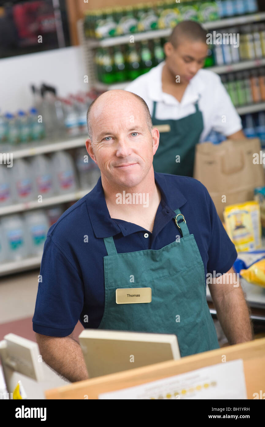 Supermarket employee and check out assistant Stock Photo - Alamy