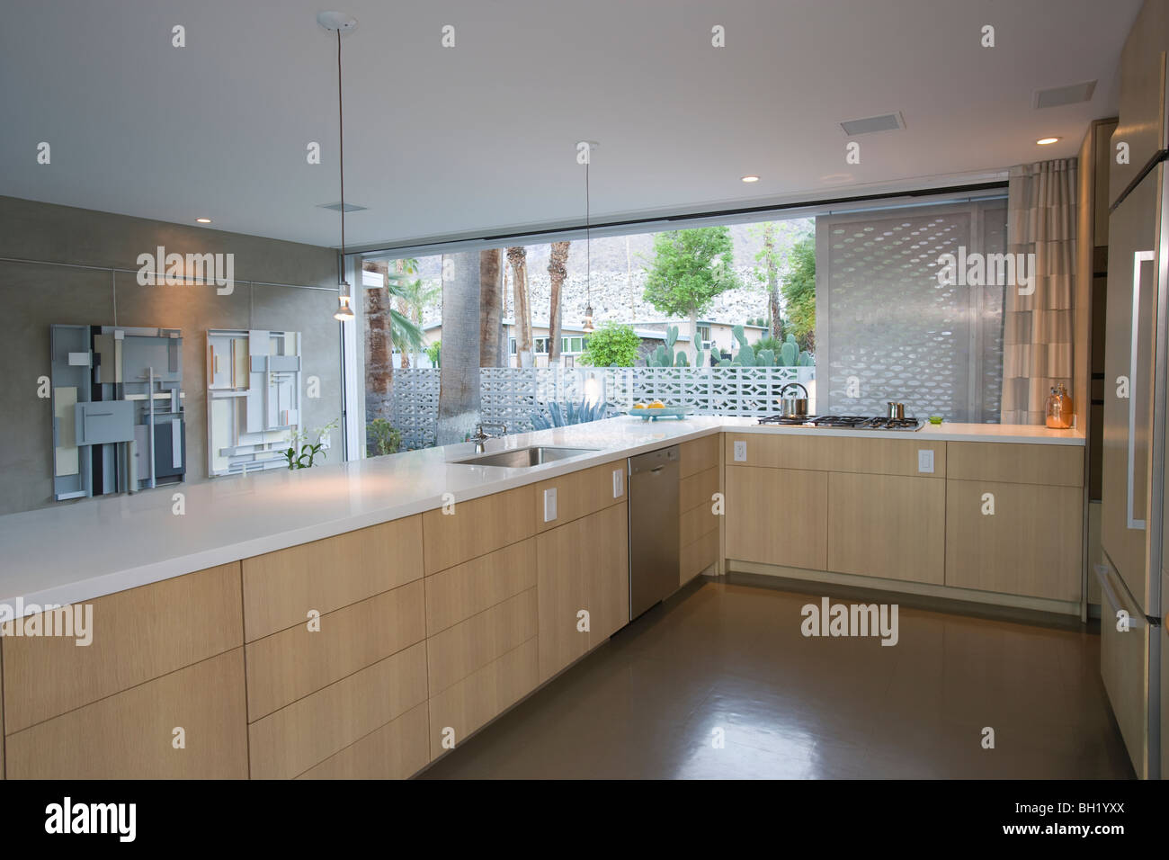 Open plan kitchen furnished in light wood, Palm Springs Stock Photo - Alamy