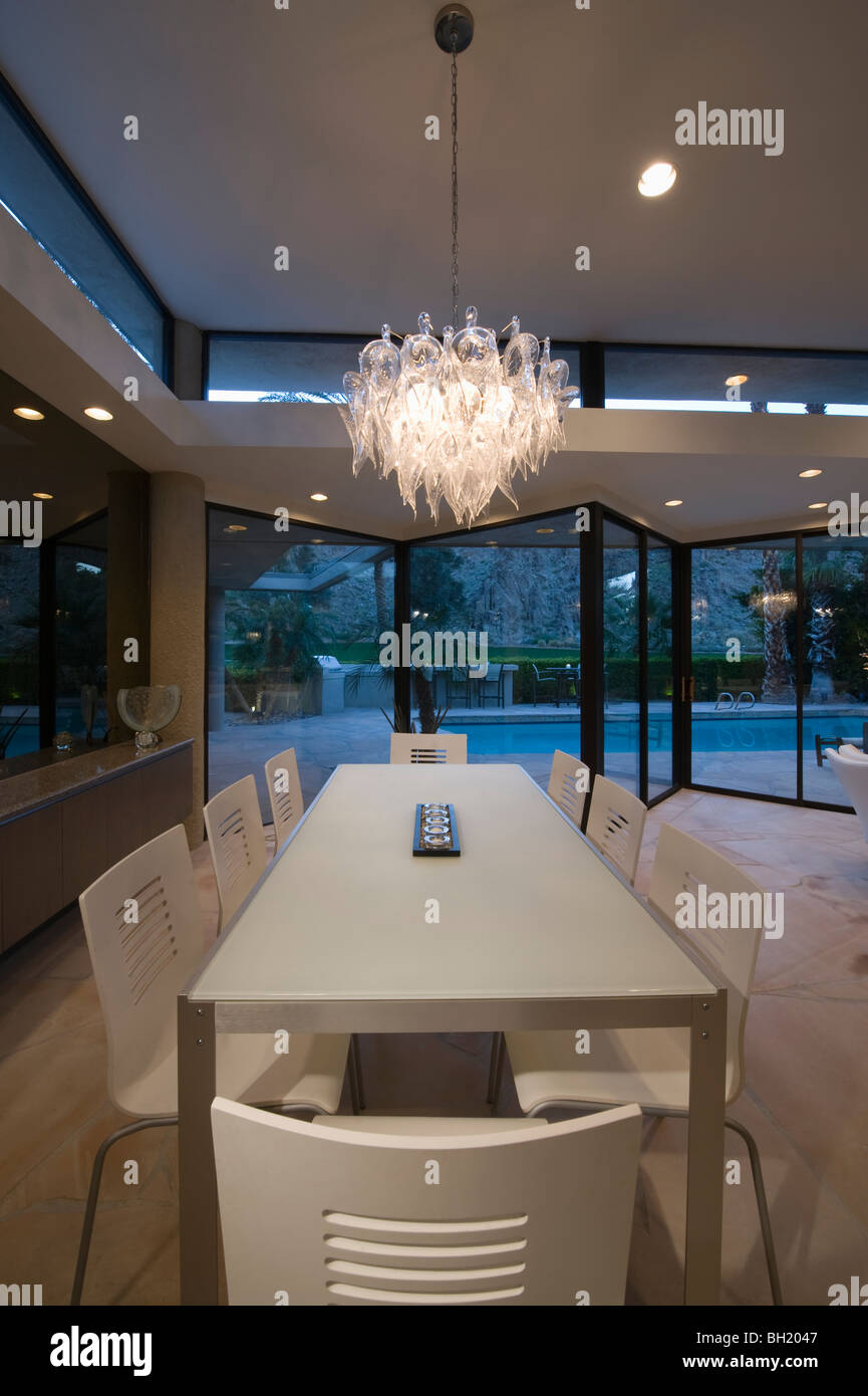 Dining table of Palm Springs home lit with glass chandelier Stock Photo ...