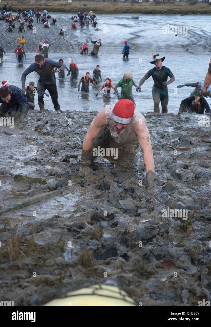a fun runner crawls towards the finish line of the maldon mud race ...