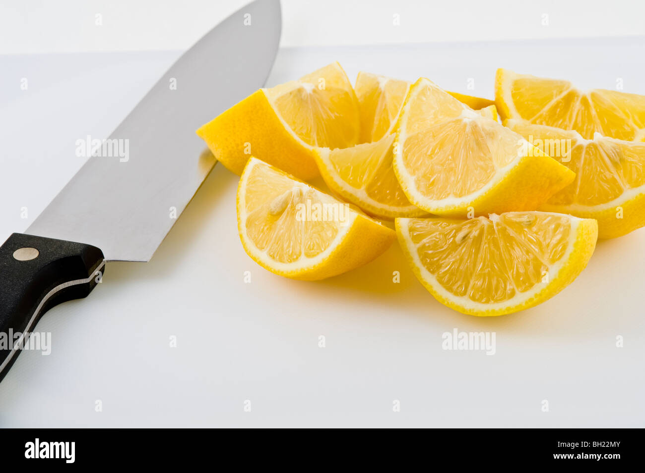 lemon quarters and knife on white background Stock Photo - Alamy