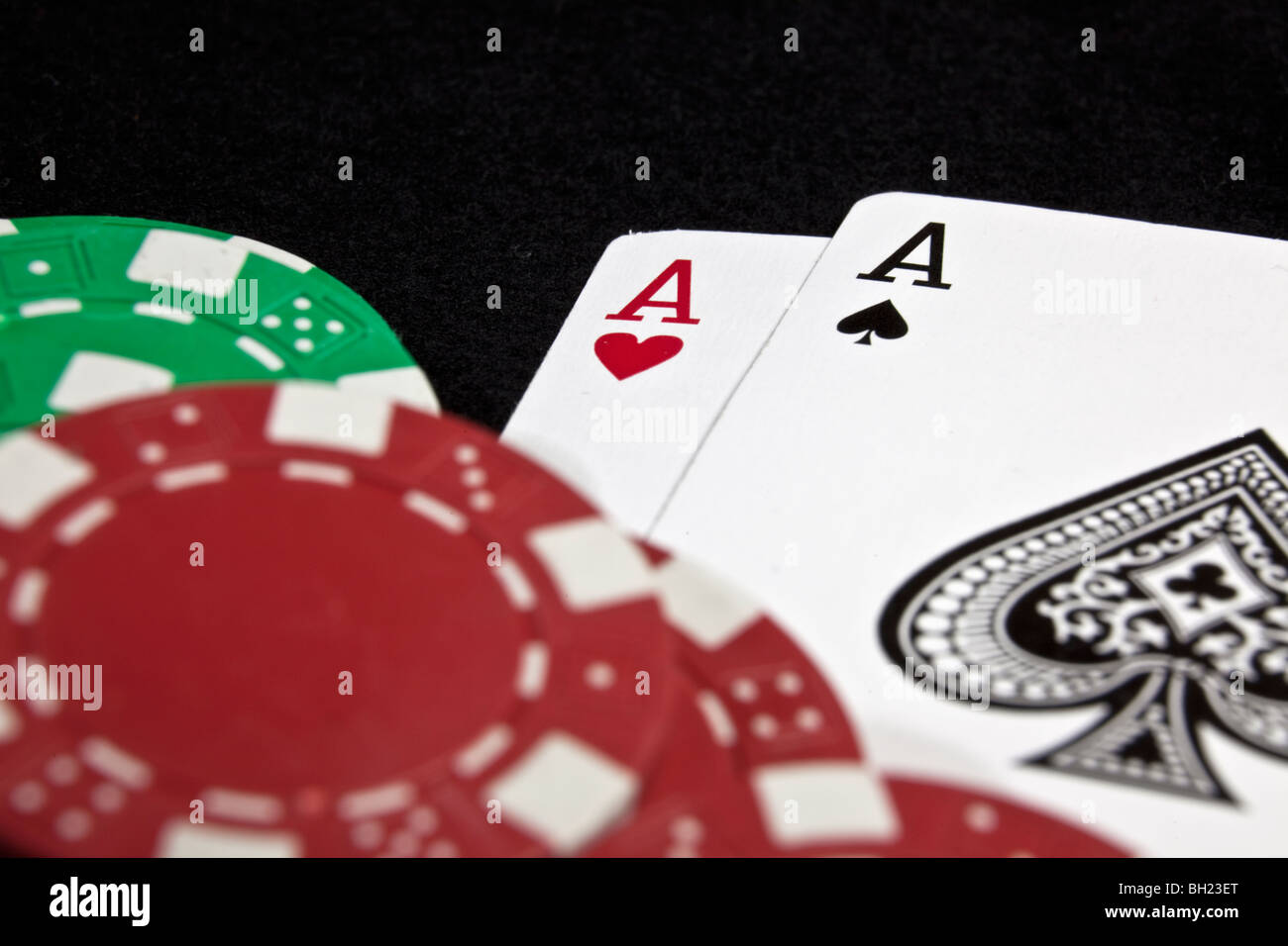 spades ass and heart ass with green and red poker chips Stock Photo - Alamy