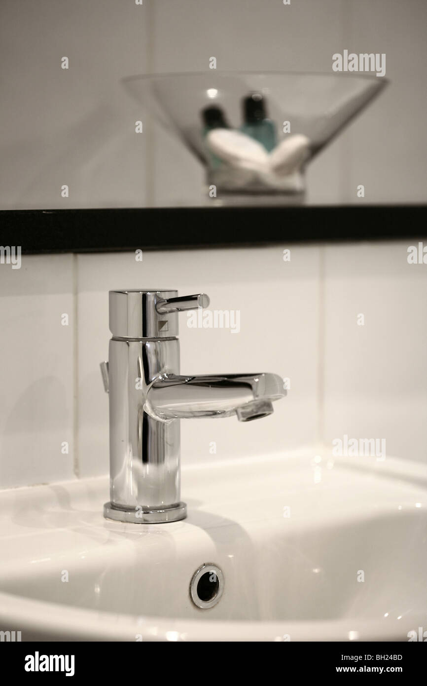 Modern chrome tap at a fancy hotel bathroom Stock Photo - Alamy