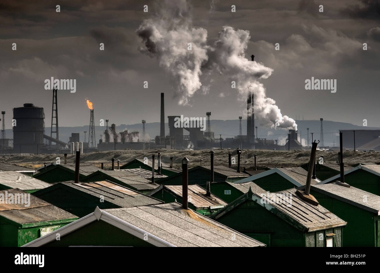 Rooftops with a factory in background Stock Photo - Alamy