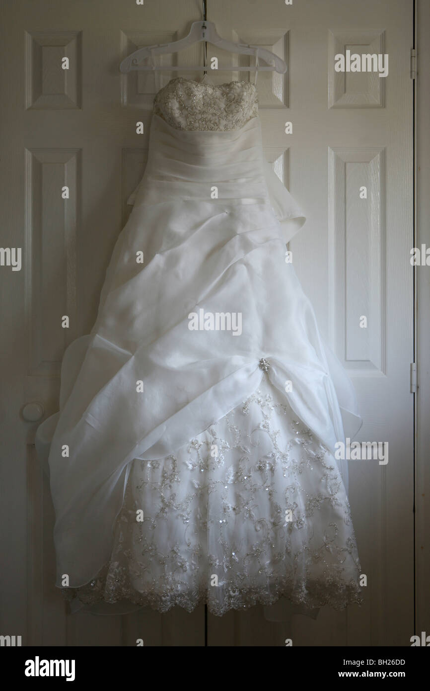 Wedding dress hung up against a wardrobe Stock Photo - Alamy