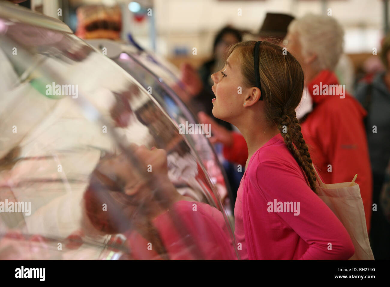 Young girl staring into a counter Stock Photo - Alamy