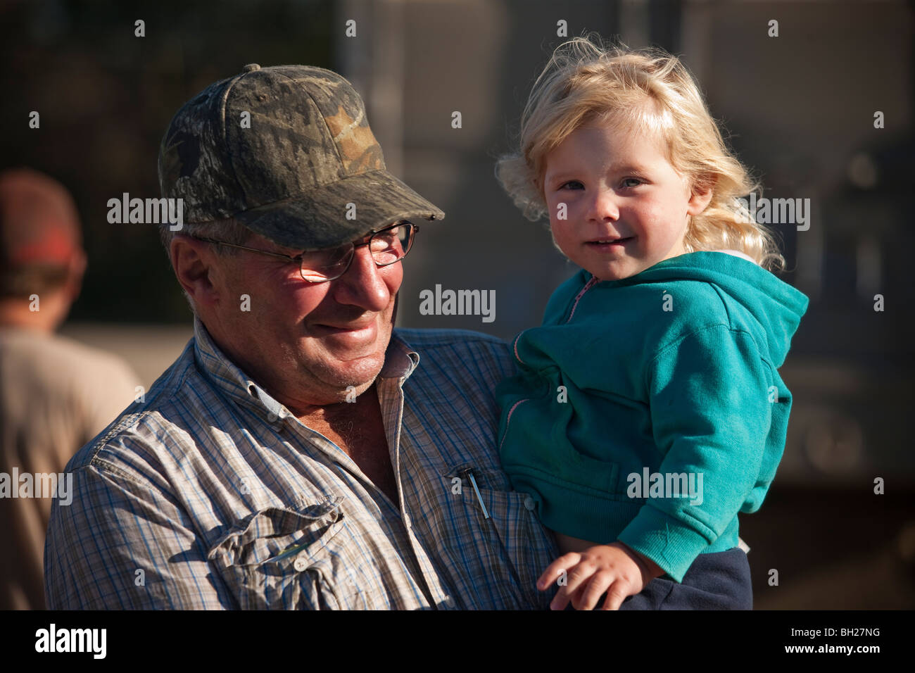 Farmer And Granddaughter In Farmyard, Redvers, Saskatchewan, Canada ...