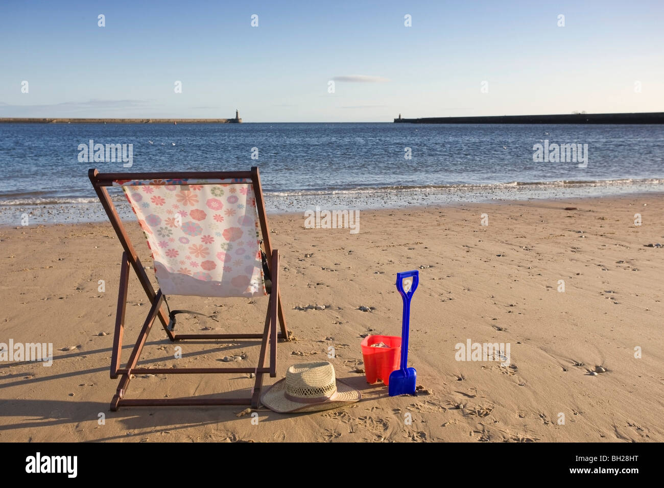 Beach chair and personal items on beach Stock Photo - Alamy