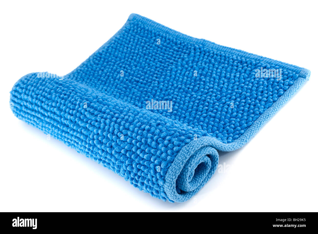 Rolled up Blue Chenille bobble bath mat Stock Photo - Alamy