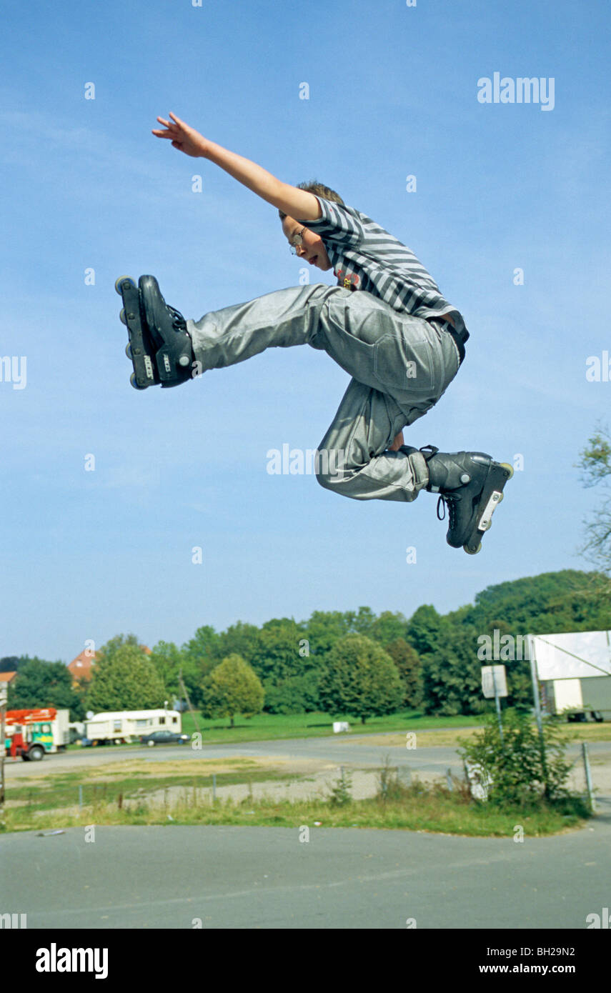 young inline-skater jumping Stock Photo - Alamy