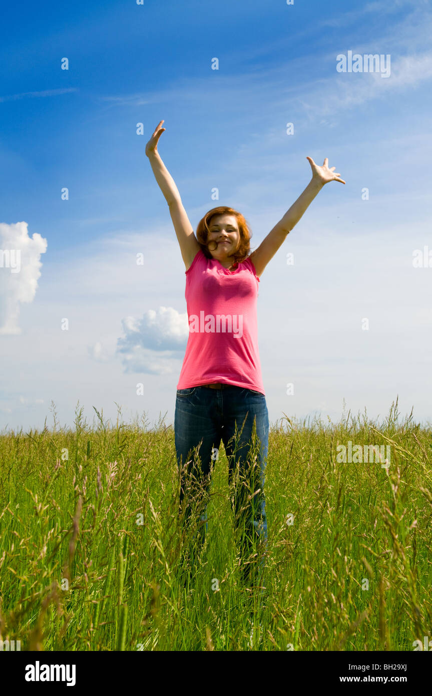 beautiful spreading her arms in the middle of a field Stock Photo - Alamy