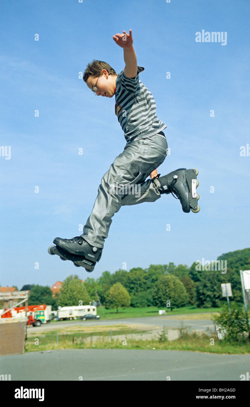 young inline-skater jumping Stock Photo - Alamy