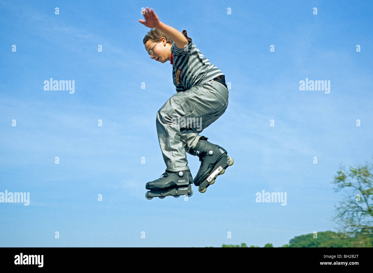 young inline-skater jumping Stock Photo - Alamy