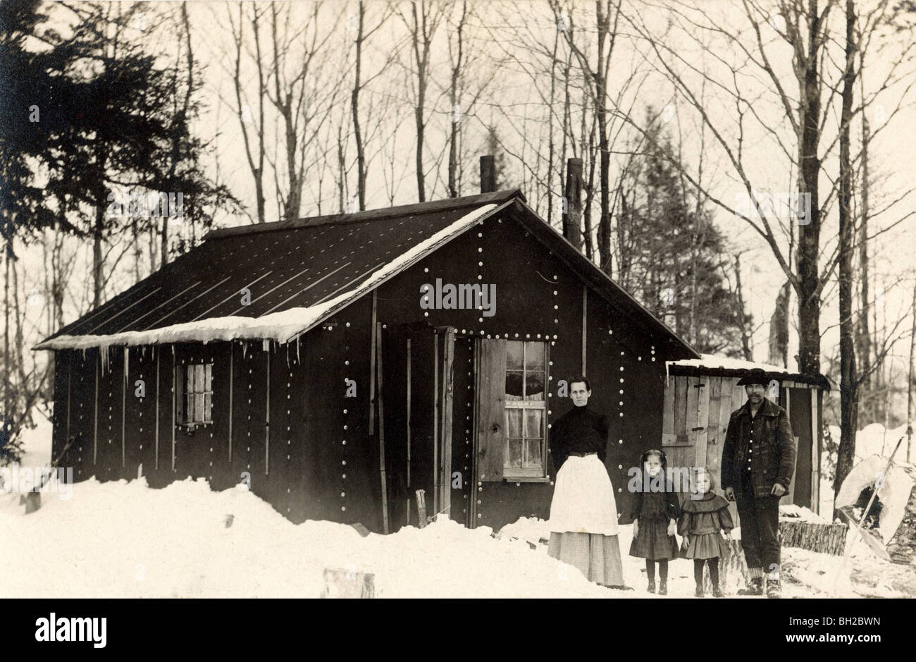 Family with Two Girls at Tarpaper Shack Stock Photo - Alamy
