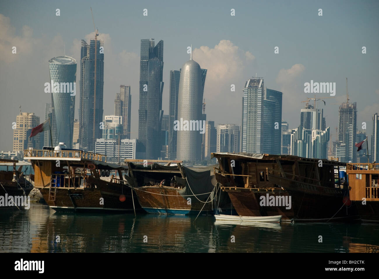 Doha, Qatar skyline with sea in foreground and traditional pearl dhow ...