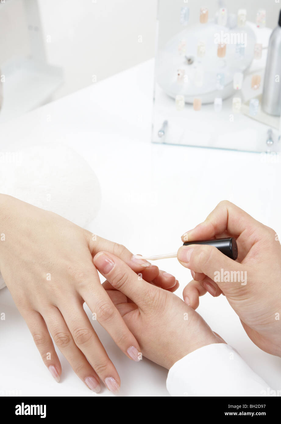 Hands, putting on some nail polish Stock Photo - Alamy
