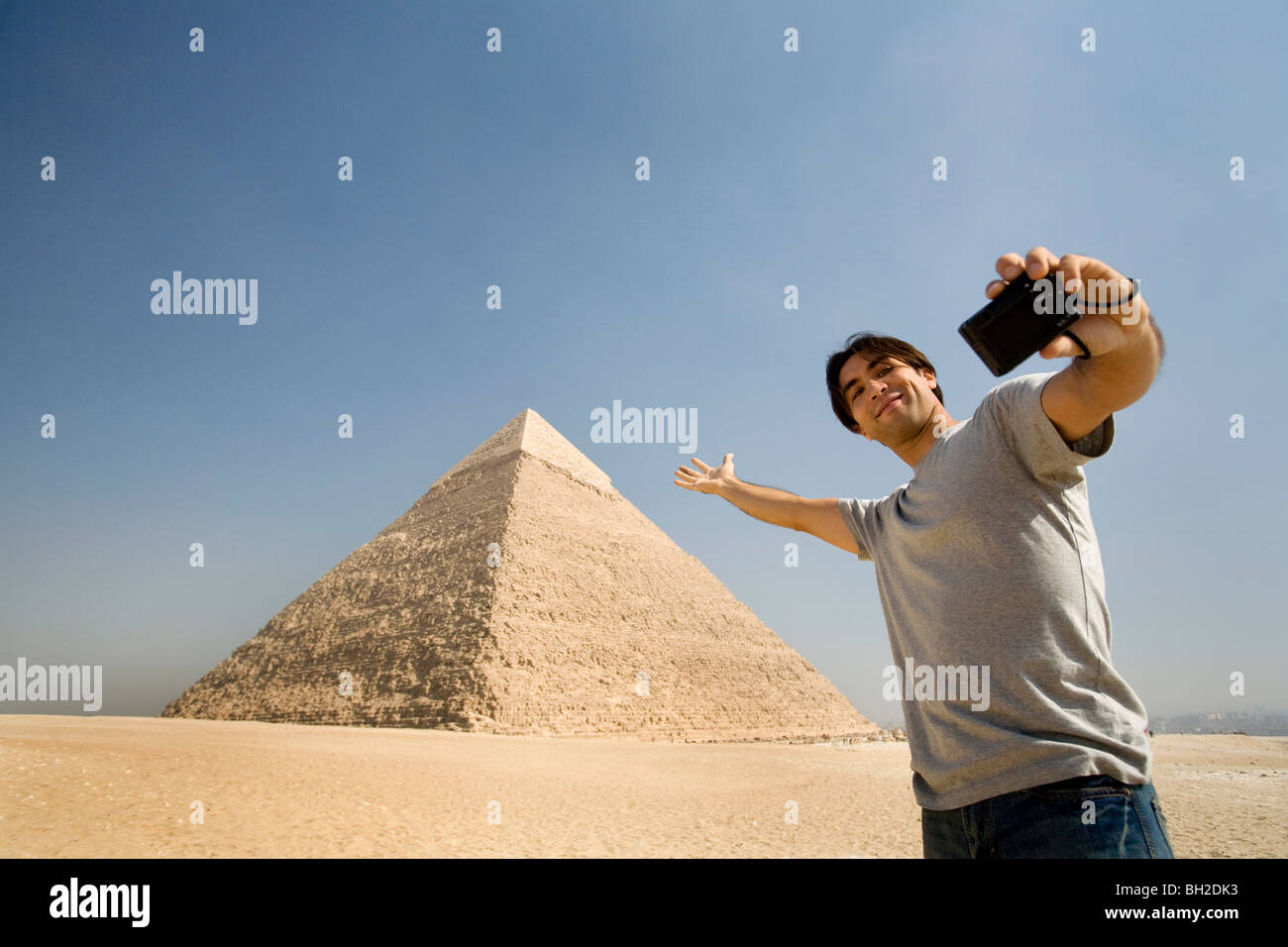 Man taking a picture of himself with Pyramid in background Stock Photo ...