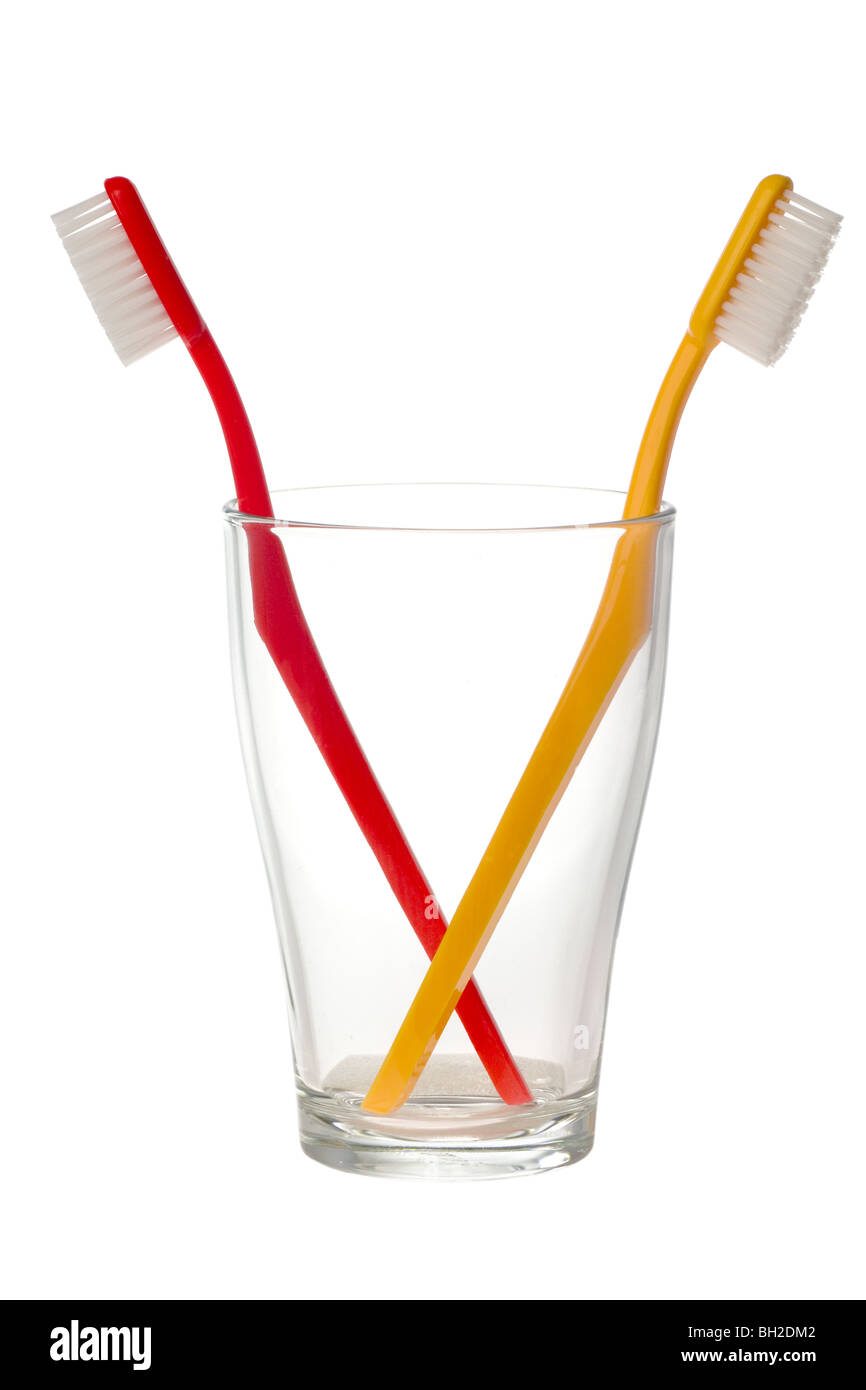 Two toothbrush in a glass isolated on white background Stock Photo - Alamy
