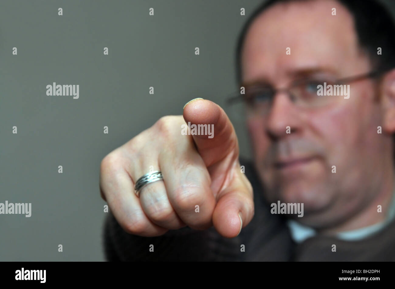 An angry man points his finger at the viewer Stock Photo - Alamy