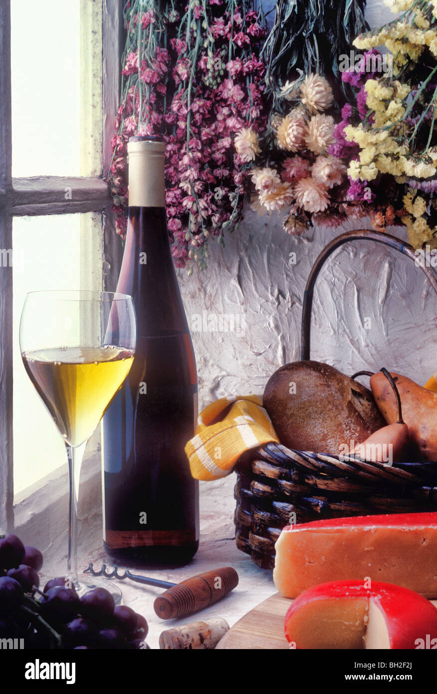 Wine bottle with glass in window Stock Photo - Alamy