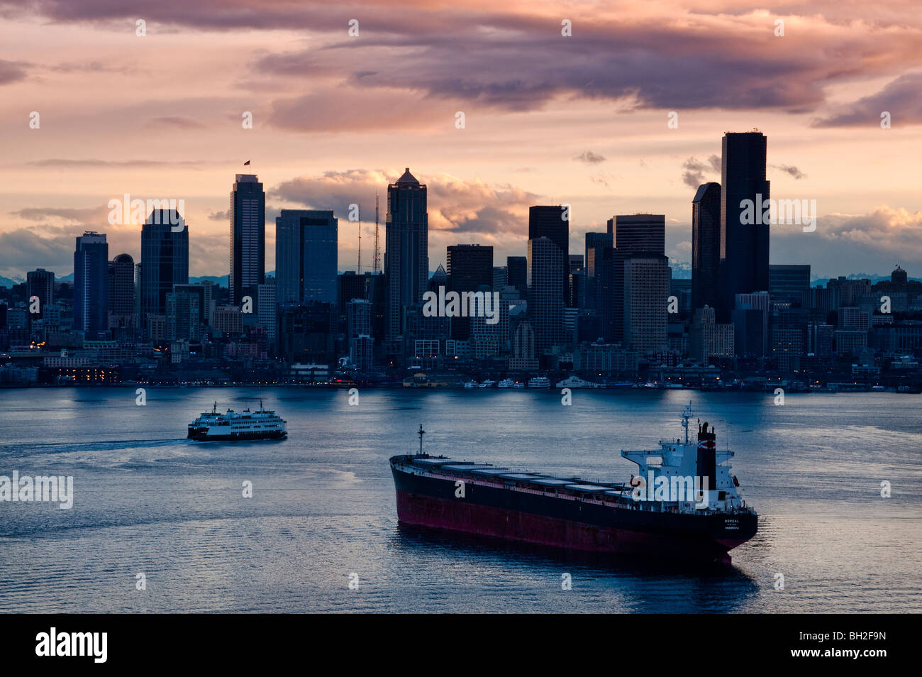 A beautiful sunrise greets the city of Seattle. Ships and ferries are ...