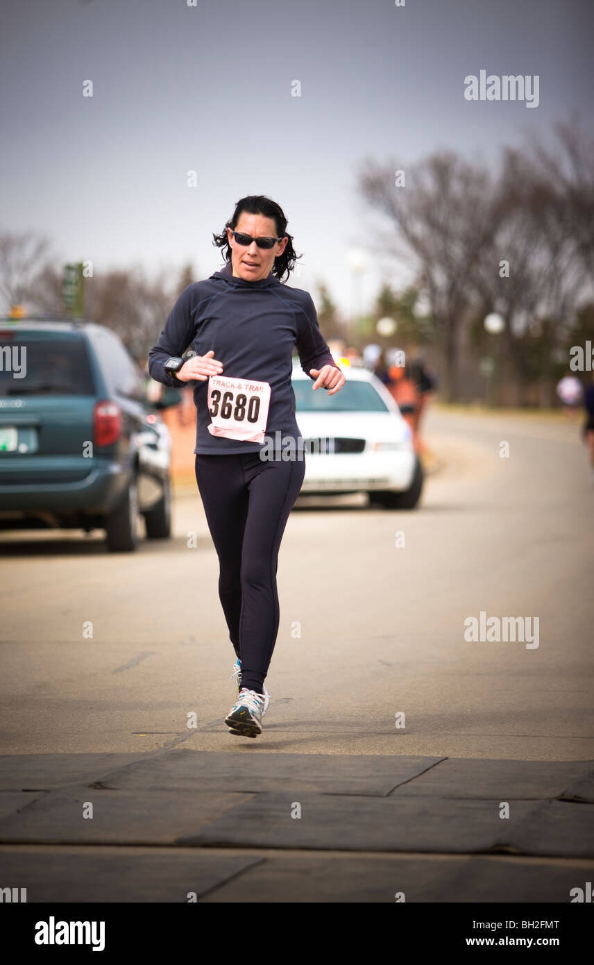 Middle aged female runner with cotton in her ears after race, Regina ...
