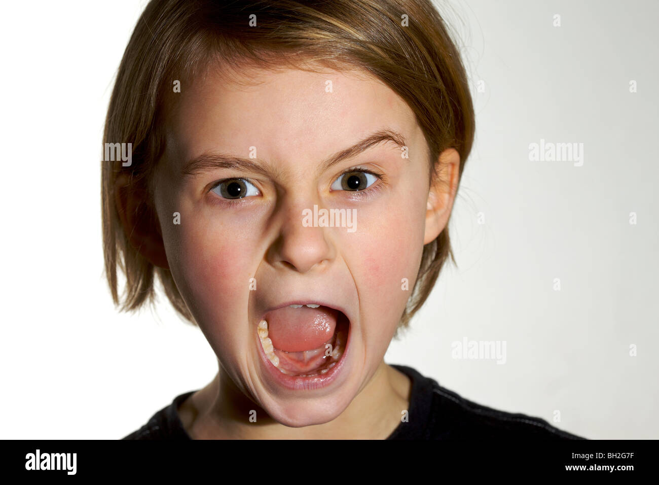 Young girl shouting screaming shocked alarmed scared surprised ...