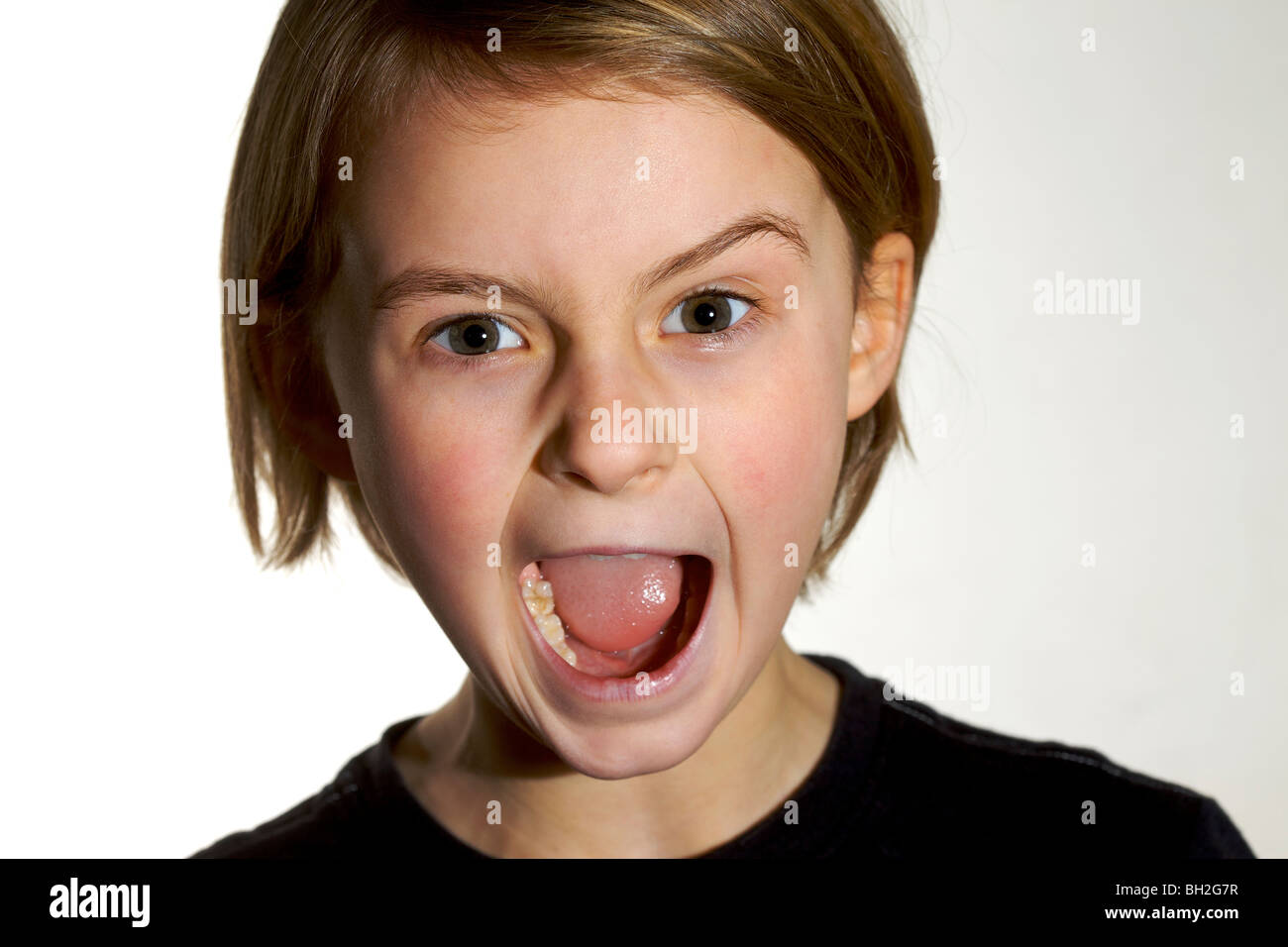 Young girl shouting screaming shocked alarmed scared surprised ...