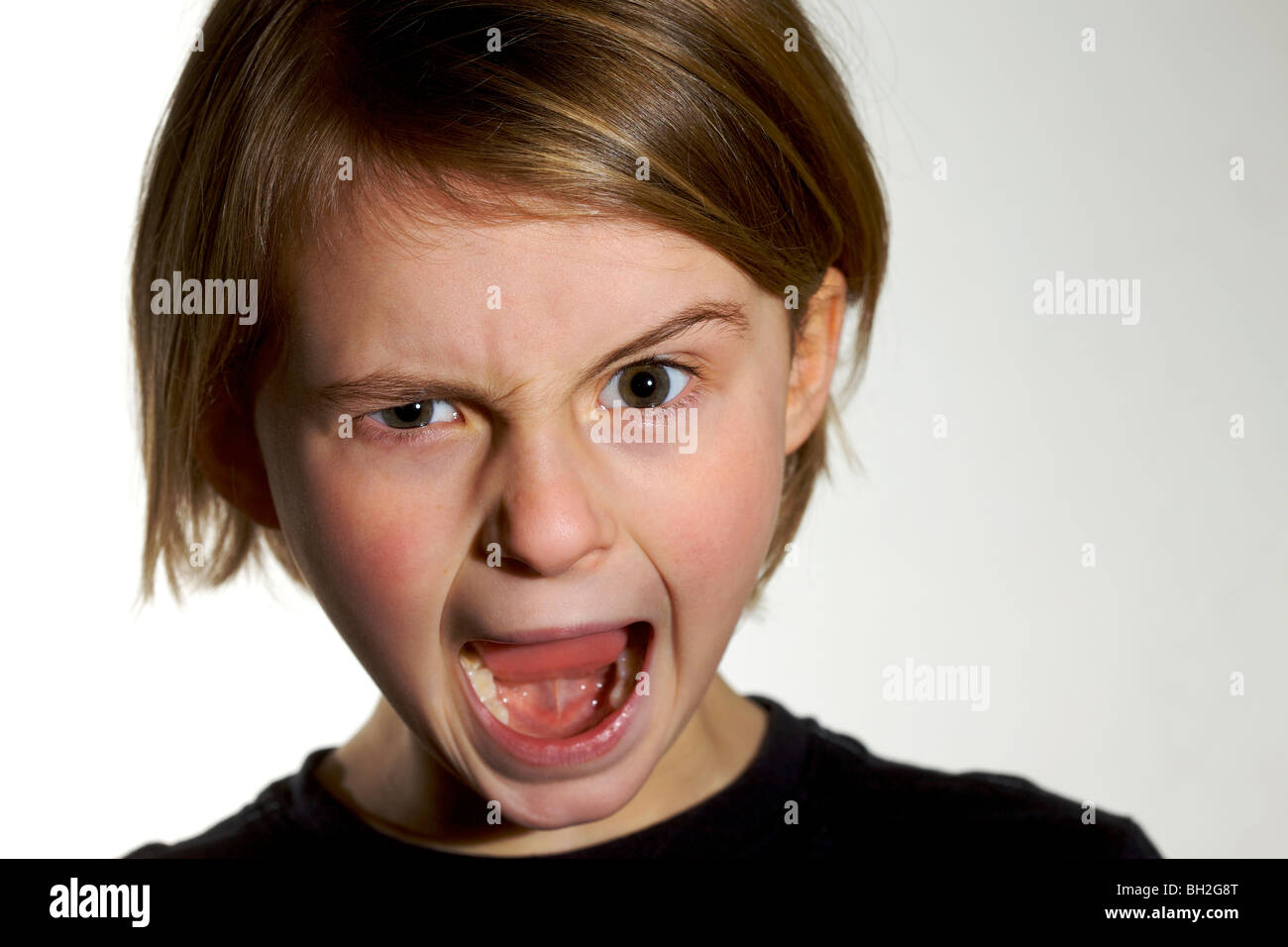 Young girl shouting screaming shocked alarmed scared surprised ...