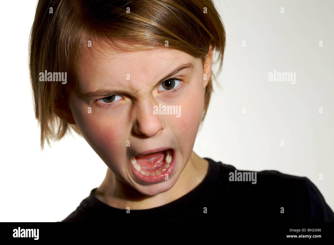 Young girl shouting screaming shocked alarmed scared surprised ...