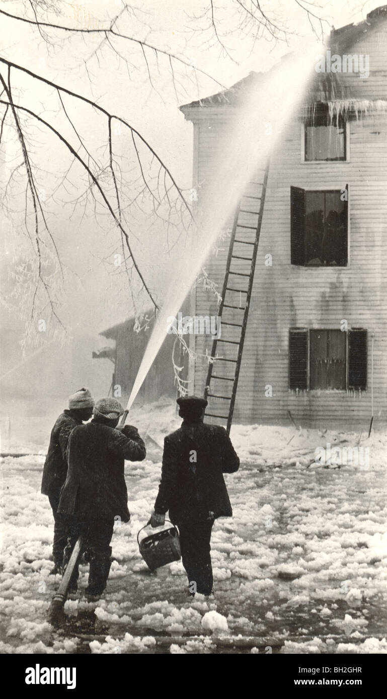 Three Firemen Dousing Burning Building Stock Photo - Alamy
